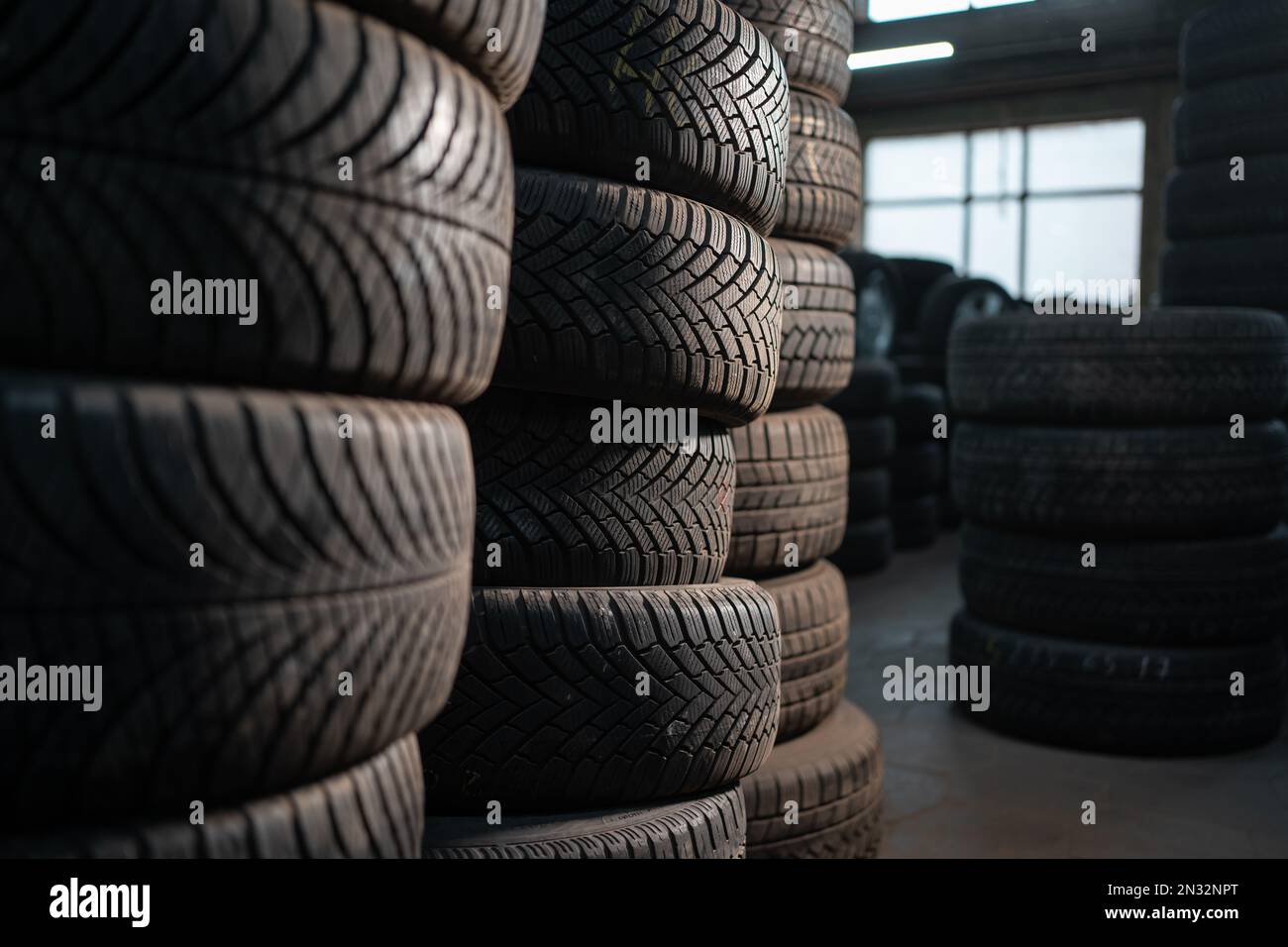 stack of car wheel tires at modern warehouse Stock Photo - Alamy