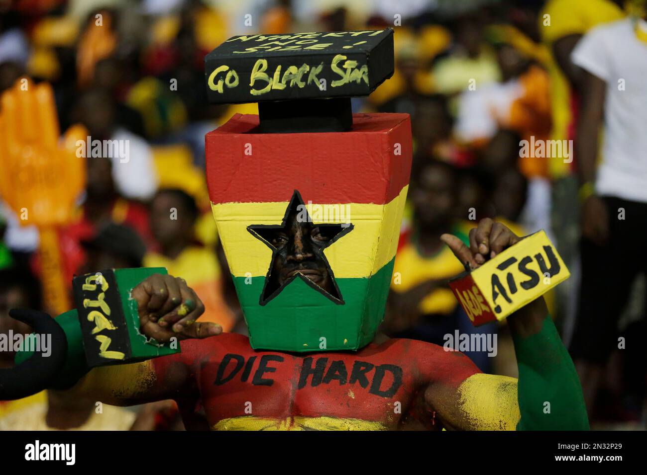 A Ghana soccer team supporter painted in Ghana flag chants before their ...