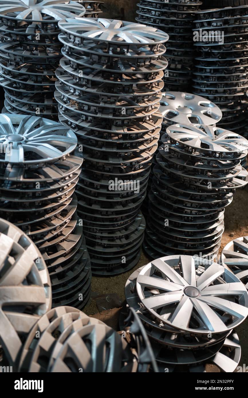 stack of various alloy wheels in tire store Stock Photo - Alamy