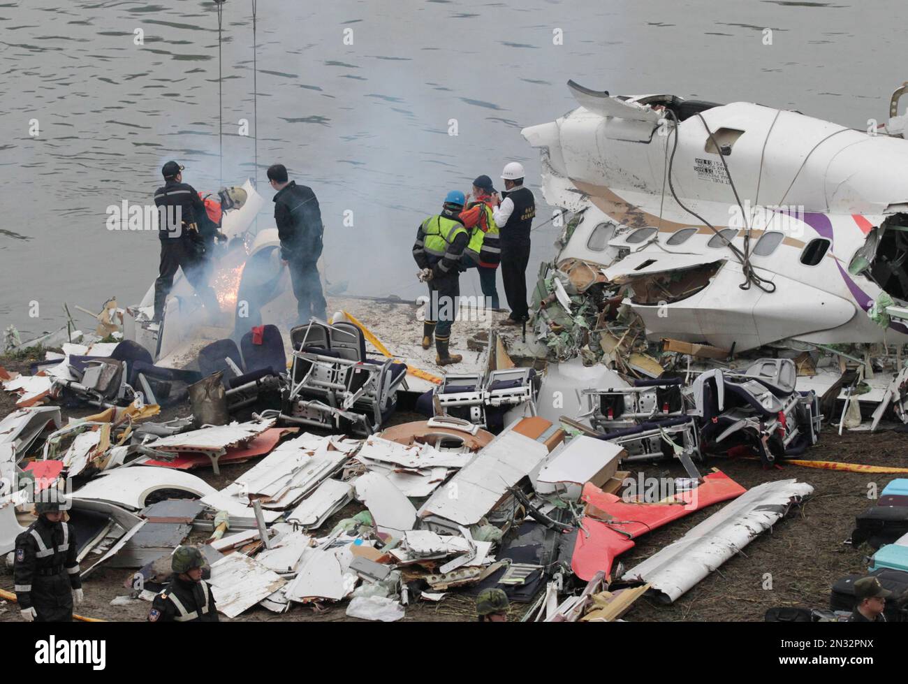 Emergency teams break down pieces of wreckage at the site of a ...
