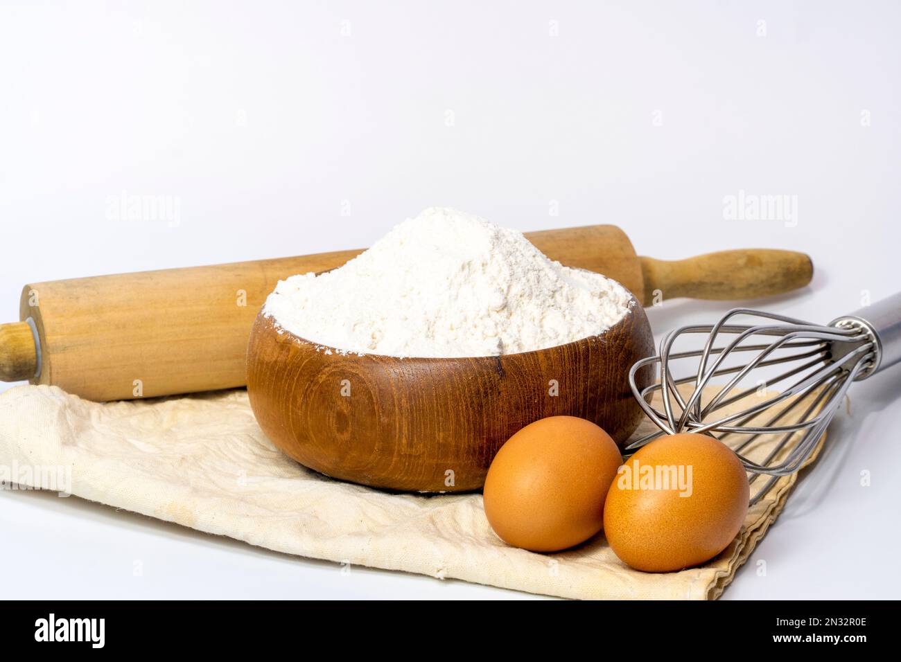 All purpose wheat flour in wooden bowl on white background Stock Photo ...