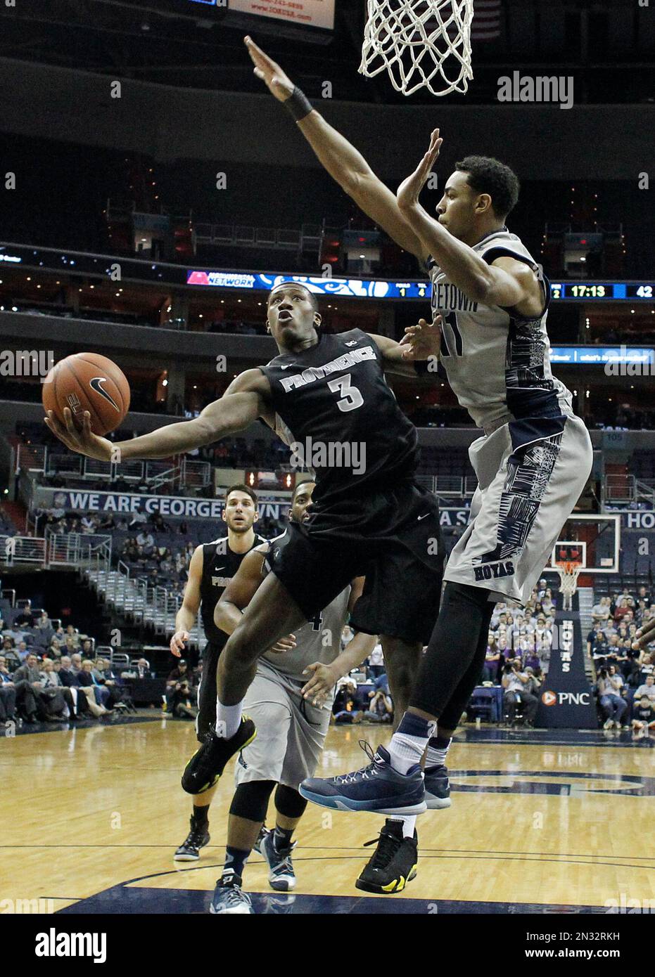 Providence guard Kris Dunn (3) shoots in front of Georgetown forward ...