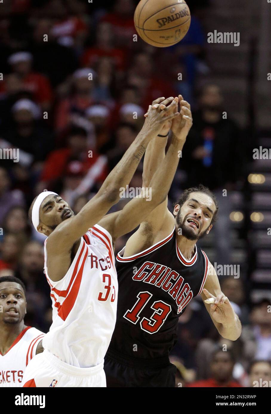 Chicago Bulls' Joakim Noah (13) passes the ball over Houston Rockets ...