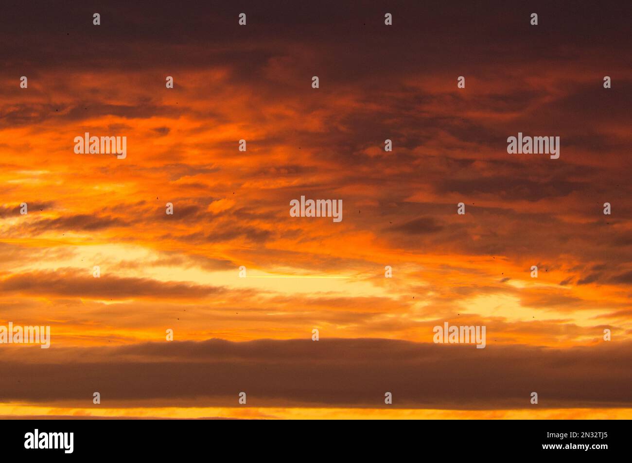 Background image with clouds in extreme colors of a sunset. The sky ...