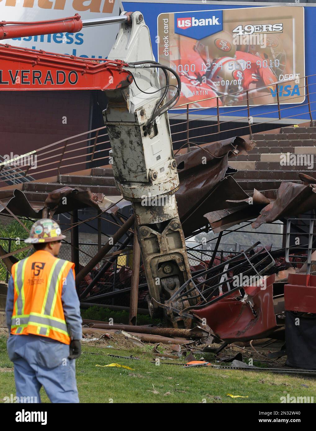 A construction worker supervises as demolition of the stands begins at ...