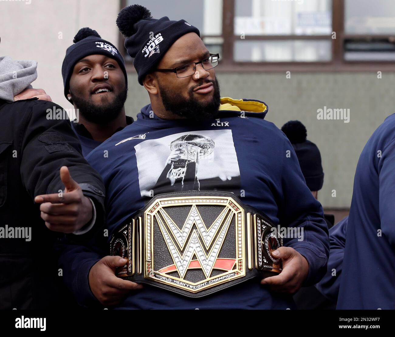 New England Patriots defensive lineman Alan Branch, center, wears a WWE ...