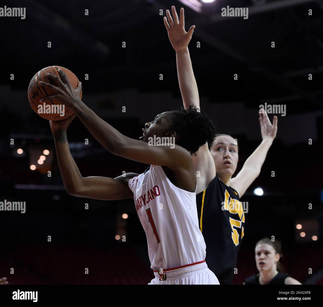 Maryland guard Laurin Mincy, left,drives to the basket as Iowa center ...