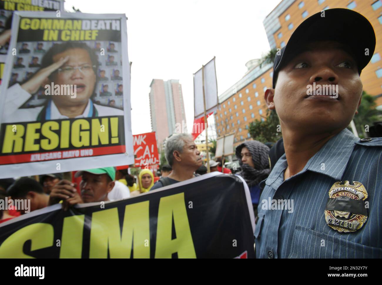 A Philippine policeman wears a black tape on his badge as a gesture of ...
