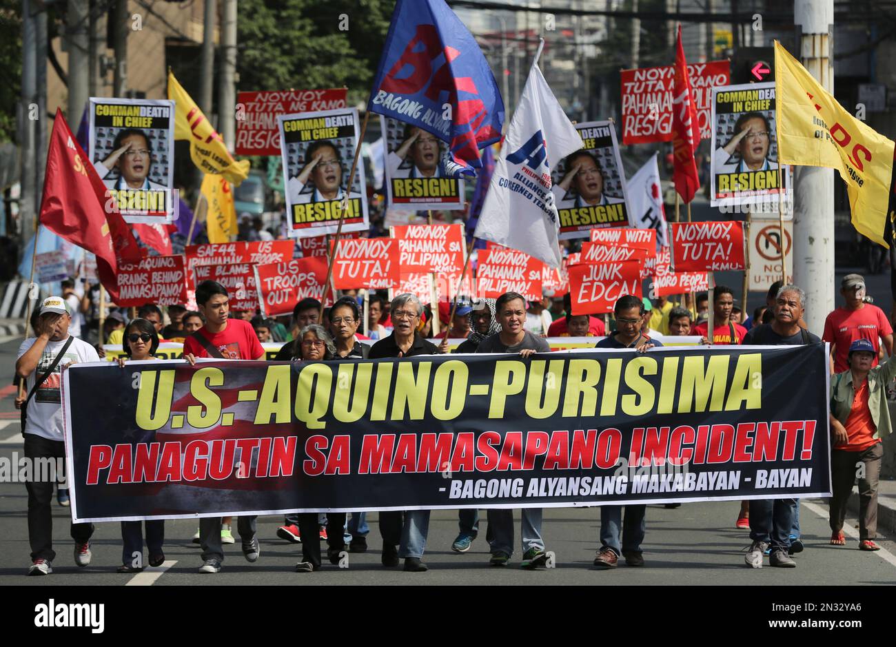 Filipino activists hold slogans as they march towards the U.S. Embassy ...