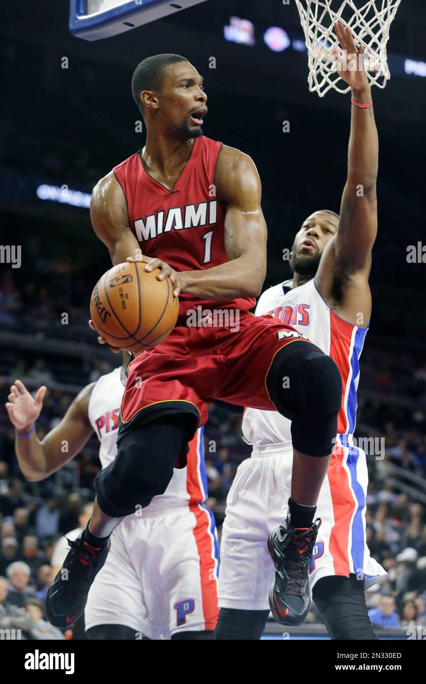 Miami Heat center Chris Bosh (1) passes around the defense of Detroit ...