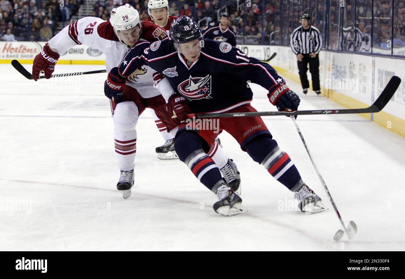 Columbus Blue Jackets' Ryan Johansen, right, keeps the puck away from ...