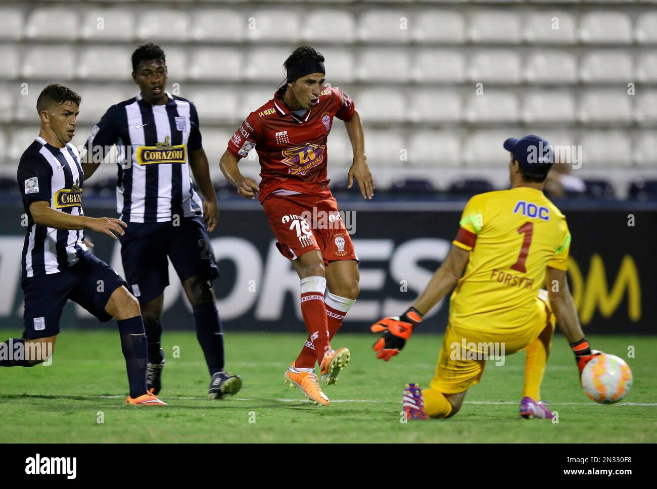 Patricio Toranzo of Argentina’s Huracan, center, scores against Peru's ...
