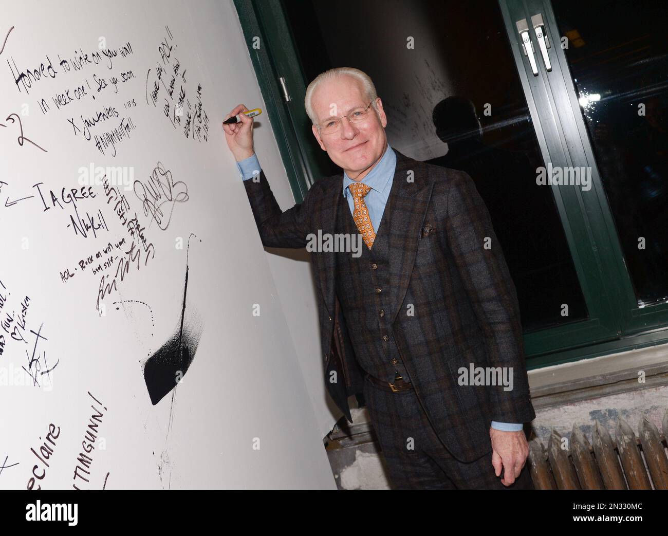 Television personality Tim Gunn signs the guest wall at AOL's BUILD ...