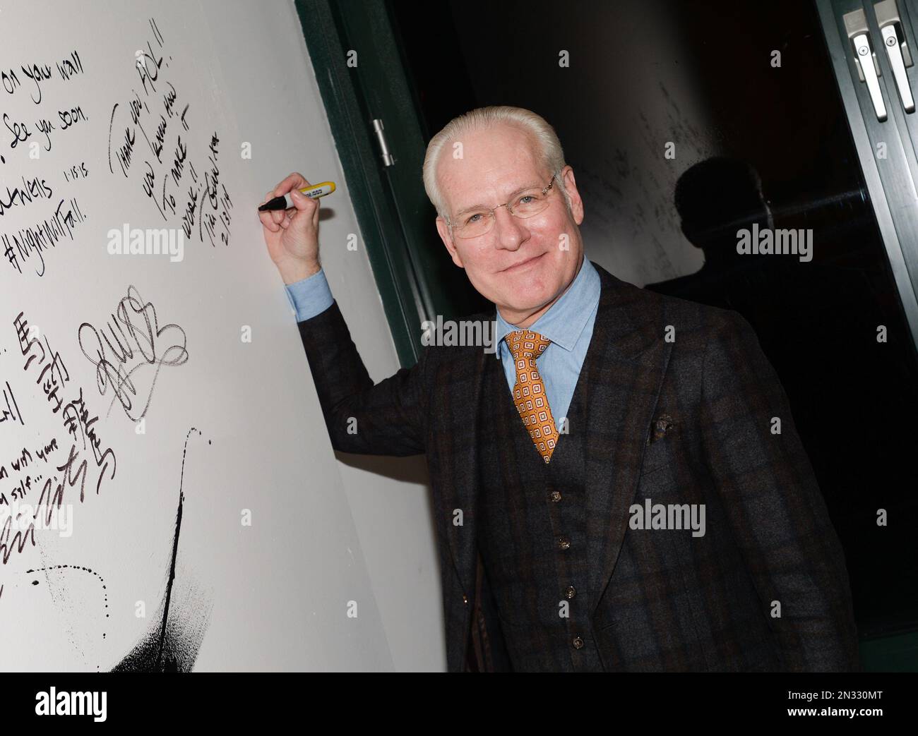 Television personality Tim Gunn signs the guest wall at AOL's BUILD ...