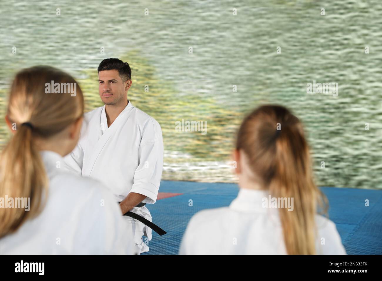 Children and coach sitting on tatami outdoors. Karate practice Stock ...