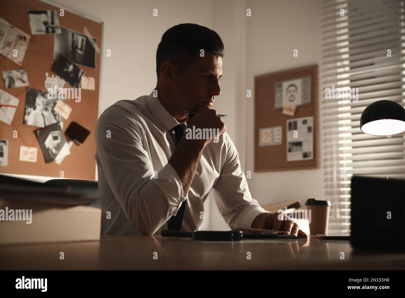 Detective at his desk hi-res stock photography and images - Alamy