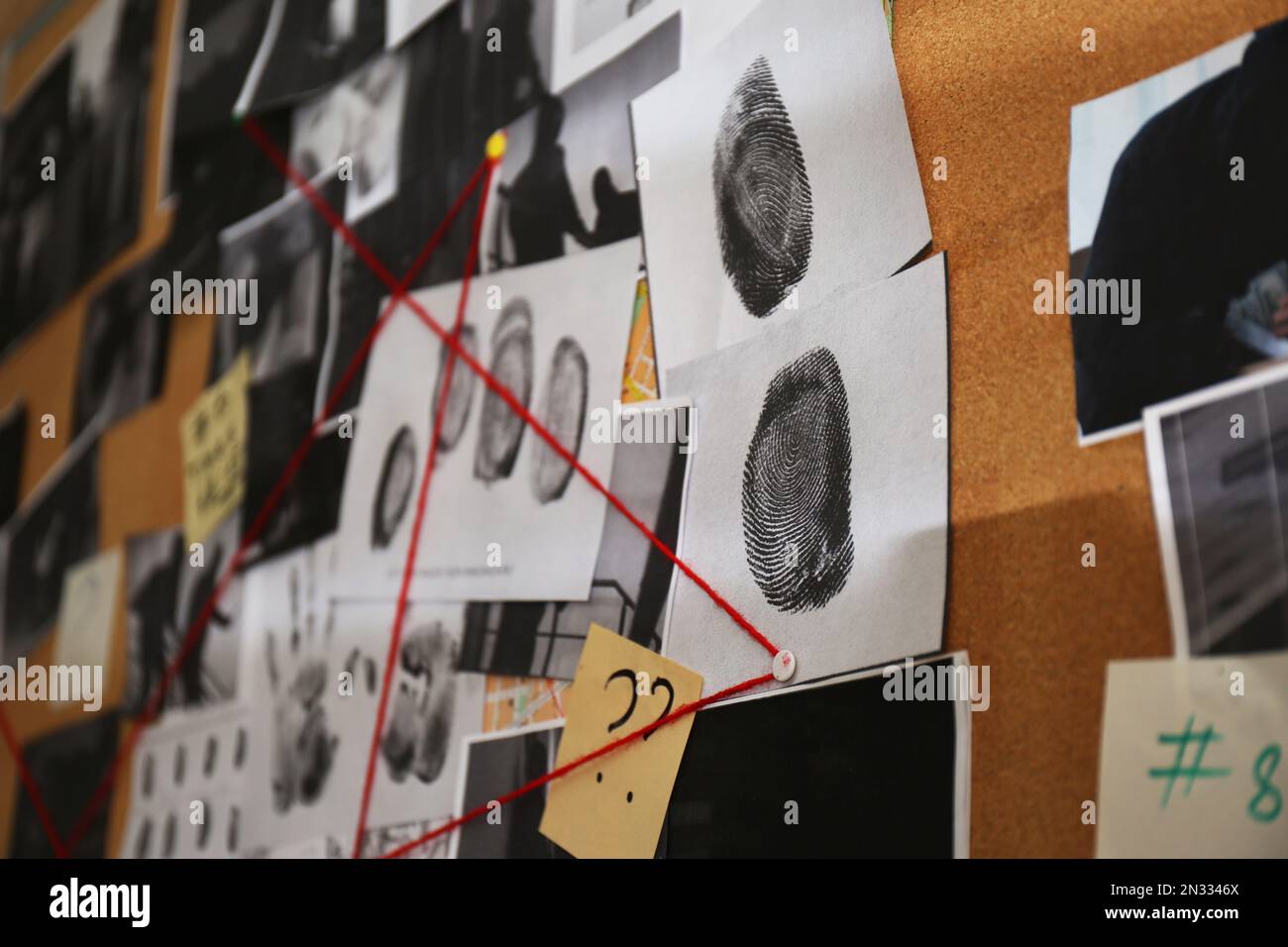 Detective board with crime scene photos, stickers, clues and red thread ...
