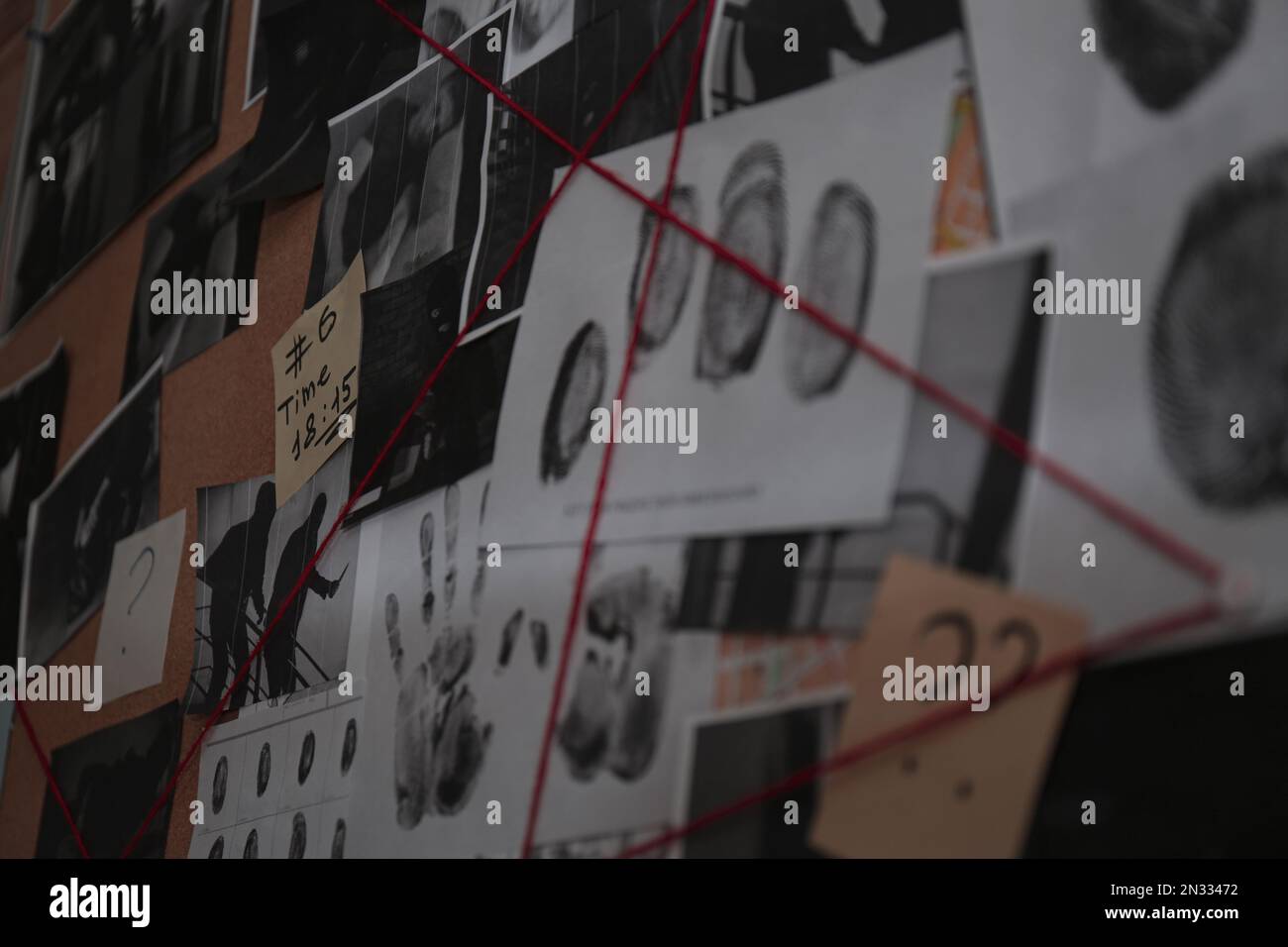 Detective board with crime scene photos, stickers, clues and red thread ...