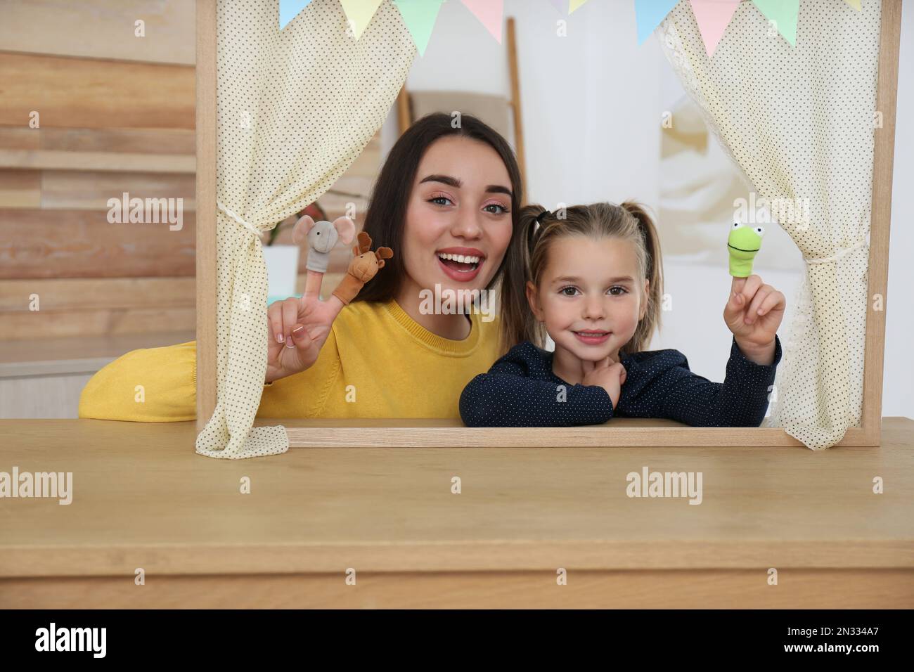 Mother and daughter performing puppet show at home Stock Photo - Alamy