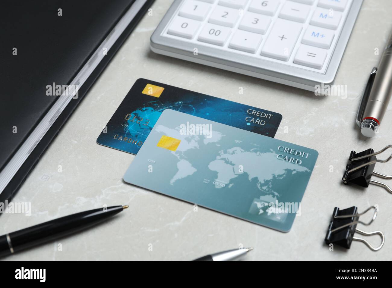 Credit cards, calculator and stationery on light grey marble table ...