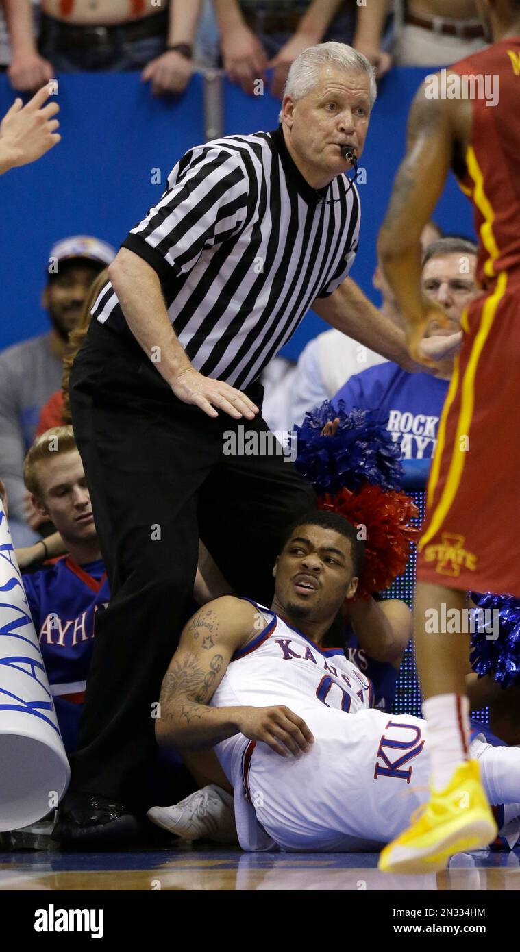 Kansas guard Frank Mason III (0) lands at the feet of referee Tom Eades ...