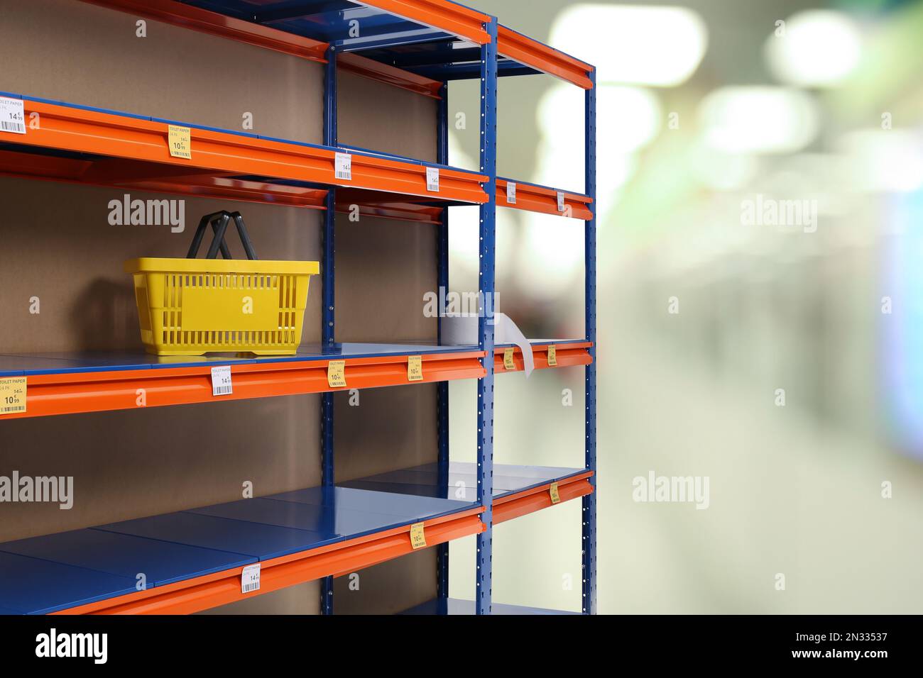 Almost empty shelves in supermarket, closeup. Product deficiency due to ...