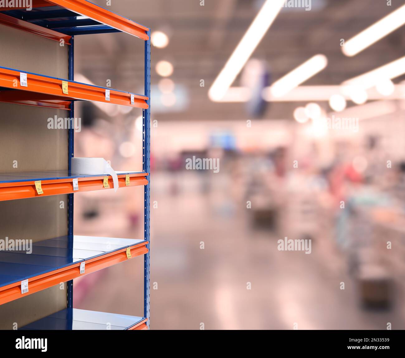 Almost empty shelves in supermarket, closeup. Product deficiency due to ...