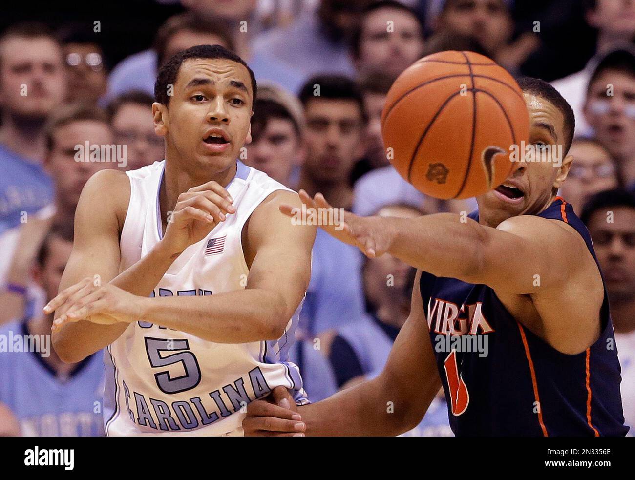 North Carolina's Marcus Paige (5) passes as Virginia's Malcolm Brogdon ...