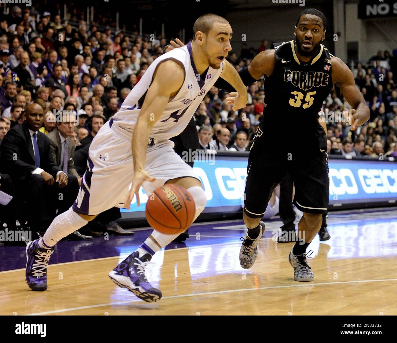 Northwestern guard Tre Demps (14) against Purdue guard Rapheal Davis ...