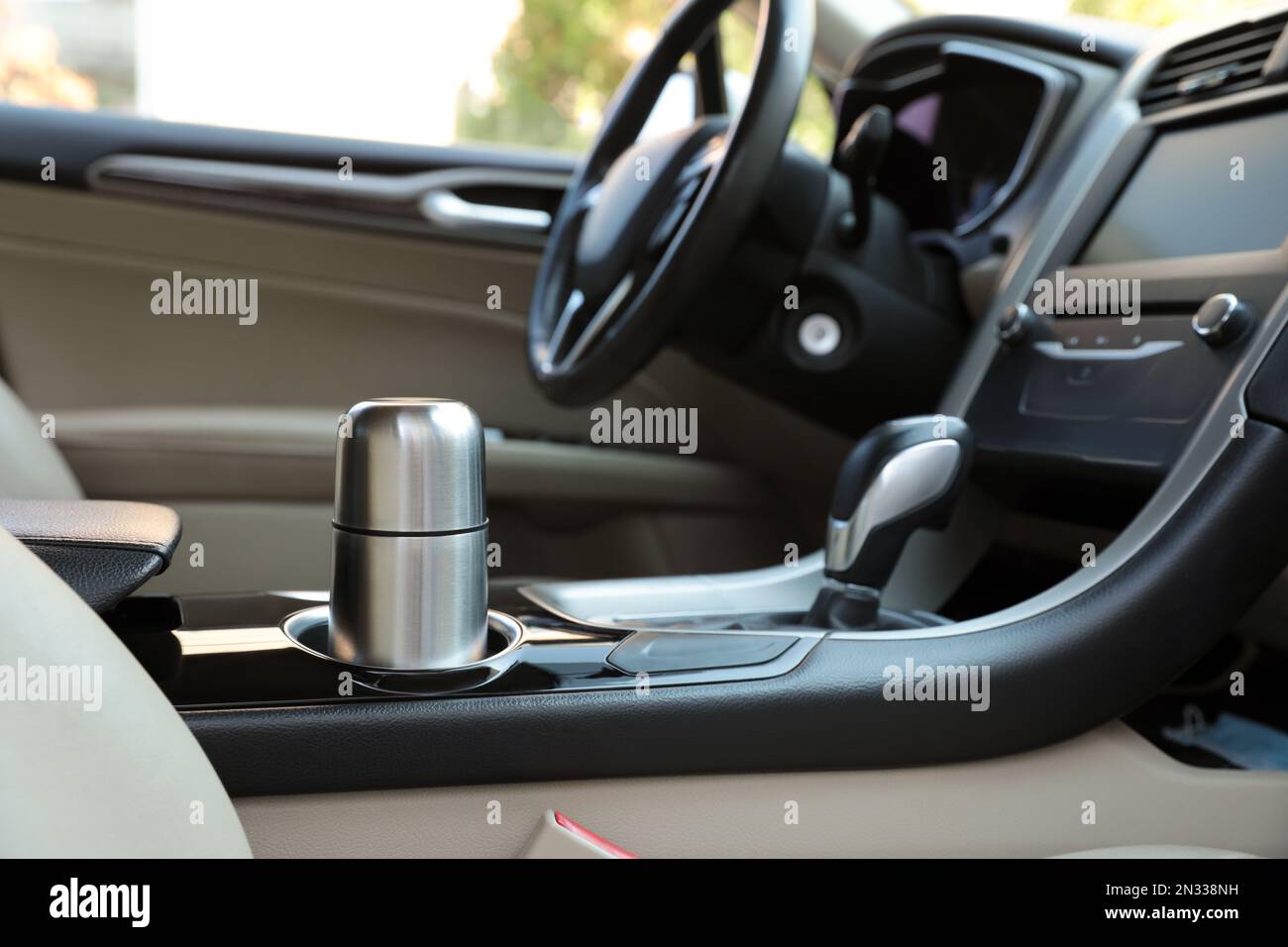 Silver thermos in holder inside of car Stock Photo - Alamy