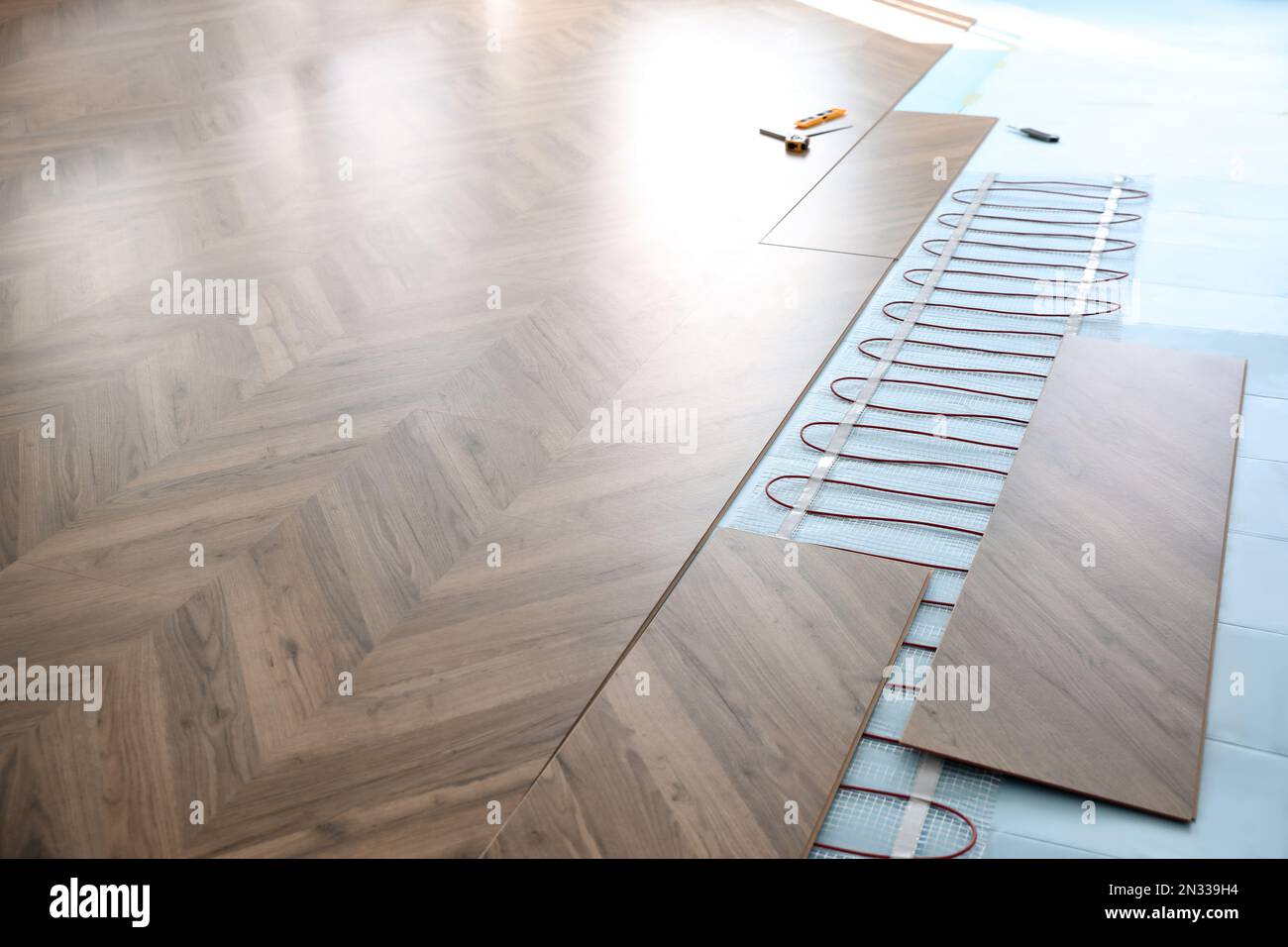 Installation of modern underfloor trace heating system indoors Stock ...