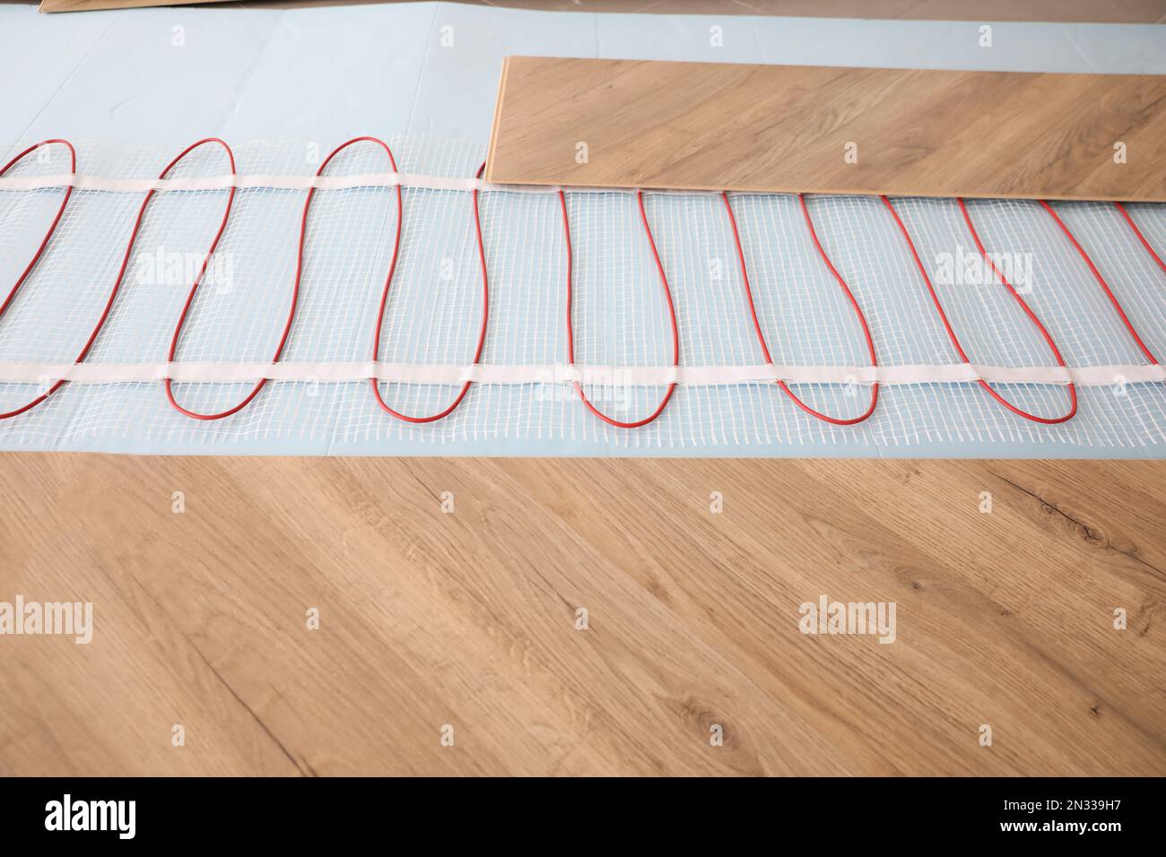 Installation of modern underfloor trace heating system indoors Stock ...