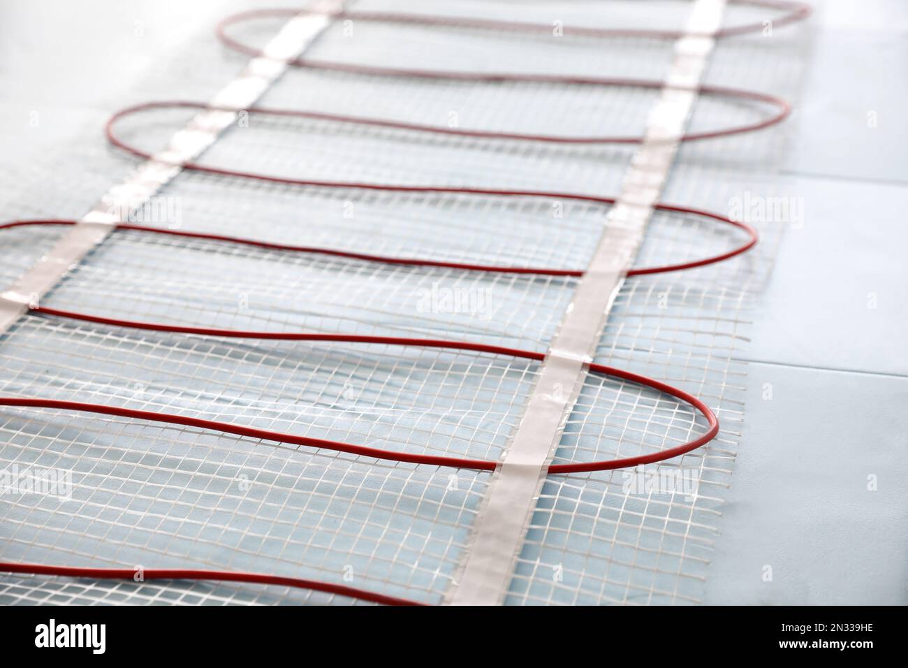 Installation of modern underfloor trace heating system indoors, closeup ...