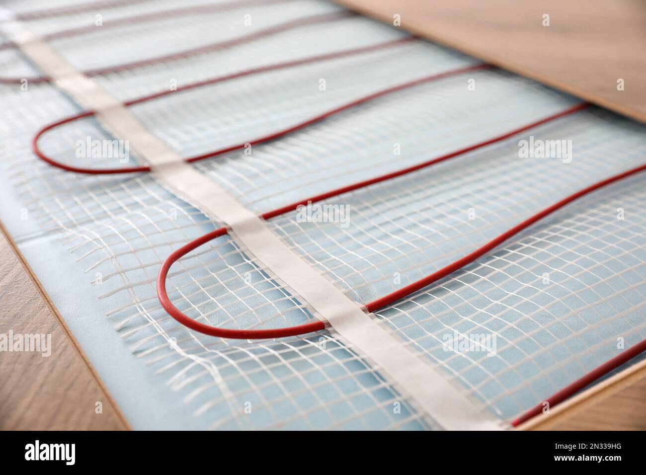 Installation of modern underfloor trace heating system indoors, closeup ...