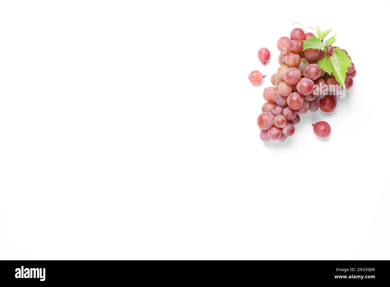 Bunch of ripe red grapes with green leaves on white background, top view Stock Photo - Alamy