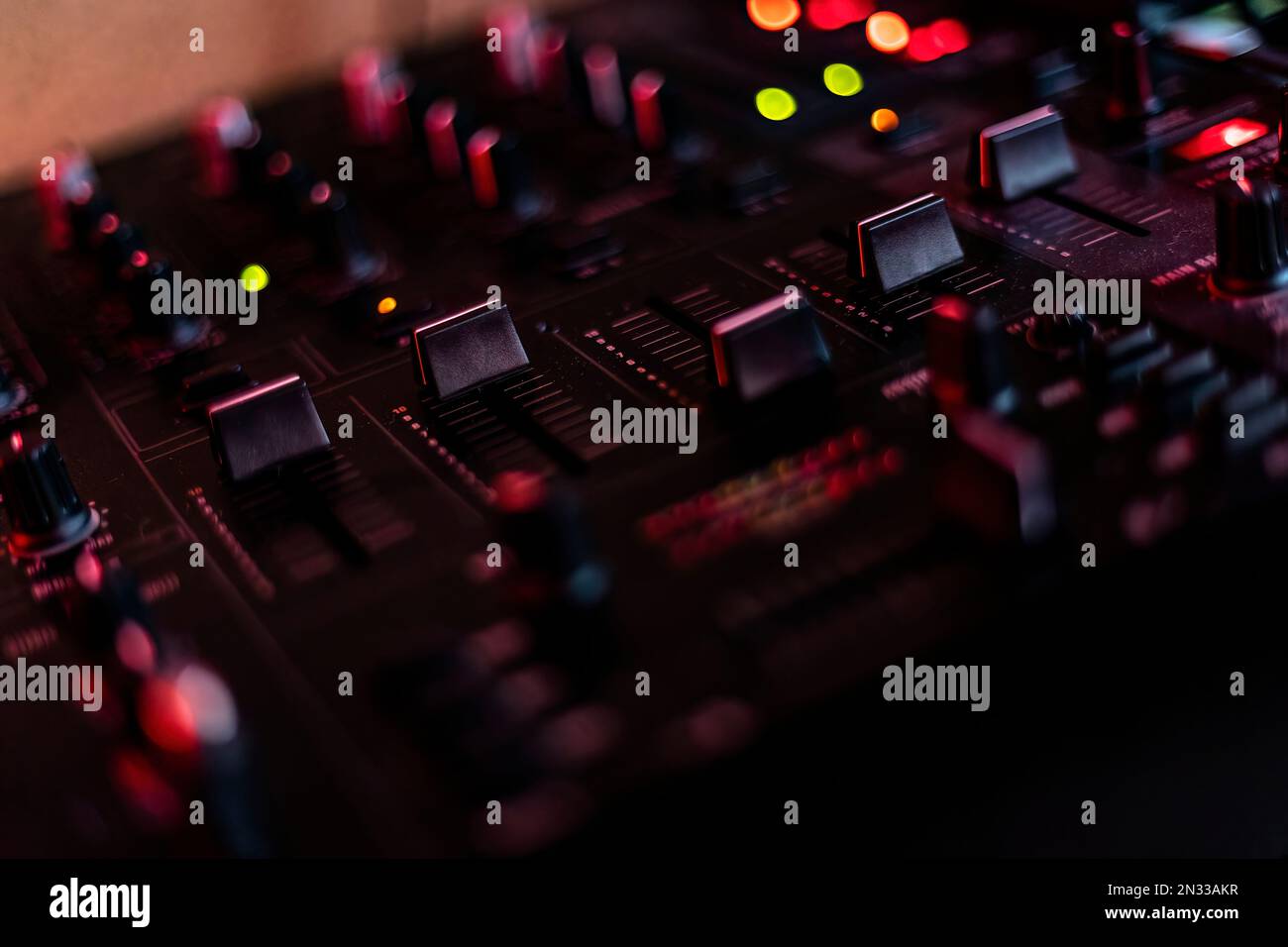 Close-up of an audio mixer with knobs and buttons, perfect for music ...