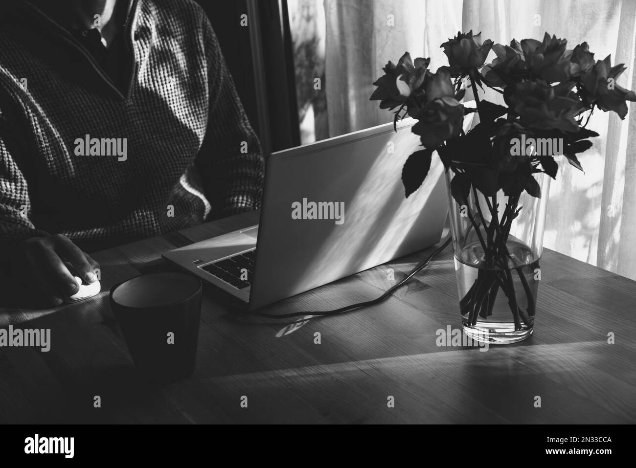 Man working from home at simple candid workplace with laptop computer ...