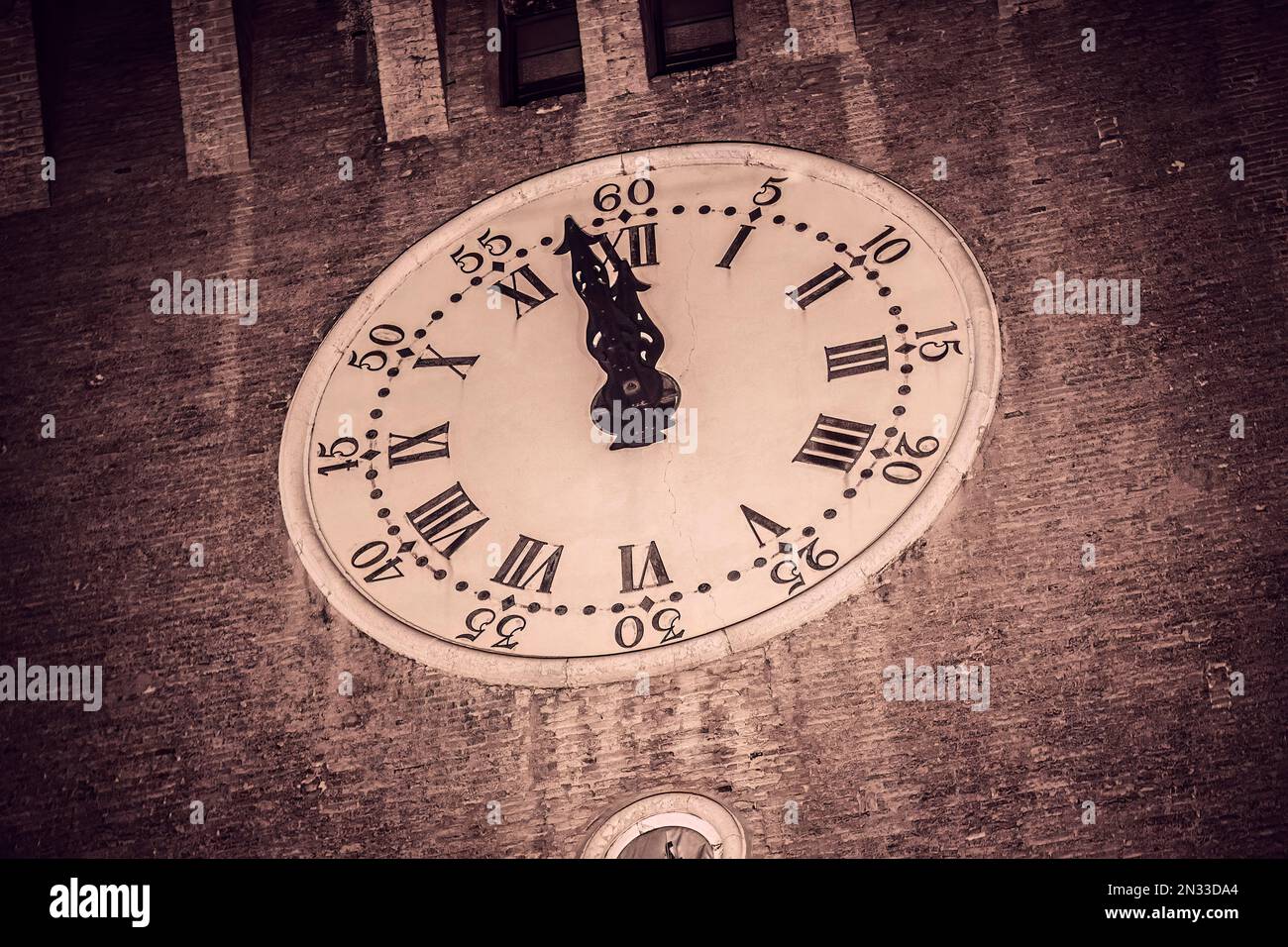 A stunning photo of the clock at Ferrara Castle at night, capturing the ...