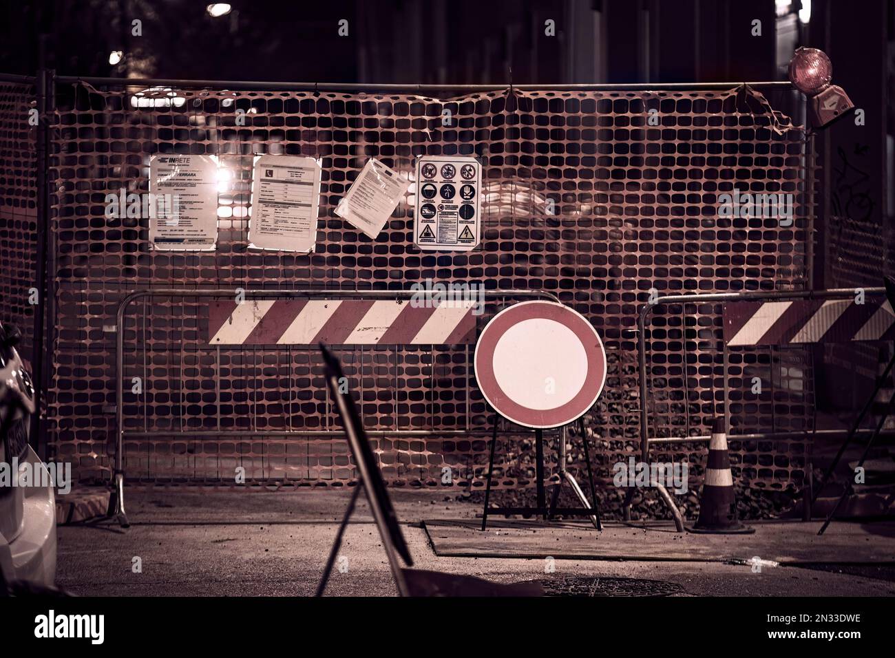 A photo of a construction site surrounded by red safety netting to keep ...