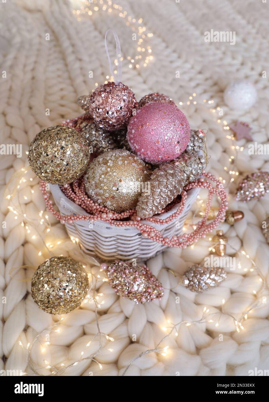 Beautiful Christmas tree baubles and fairy lights on white knitted ...