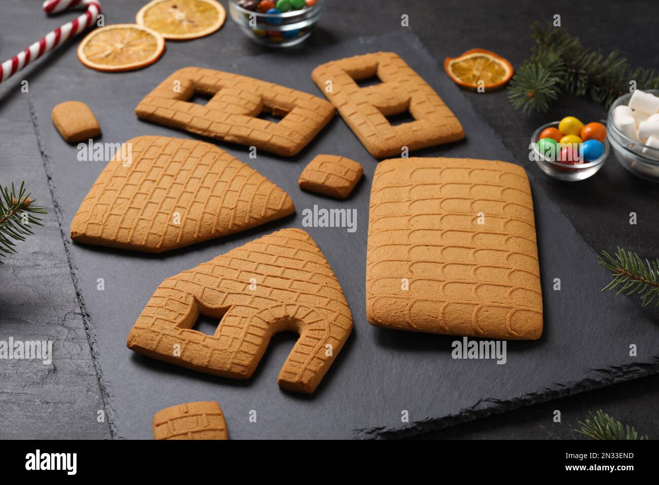 Parts of gingerbread house on black table, closeup Stock Photo - Alamy
