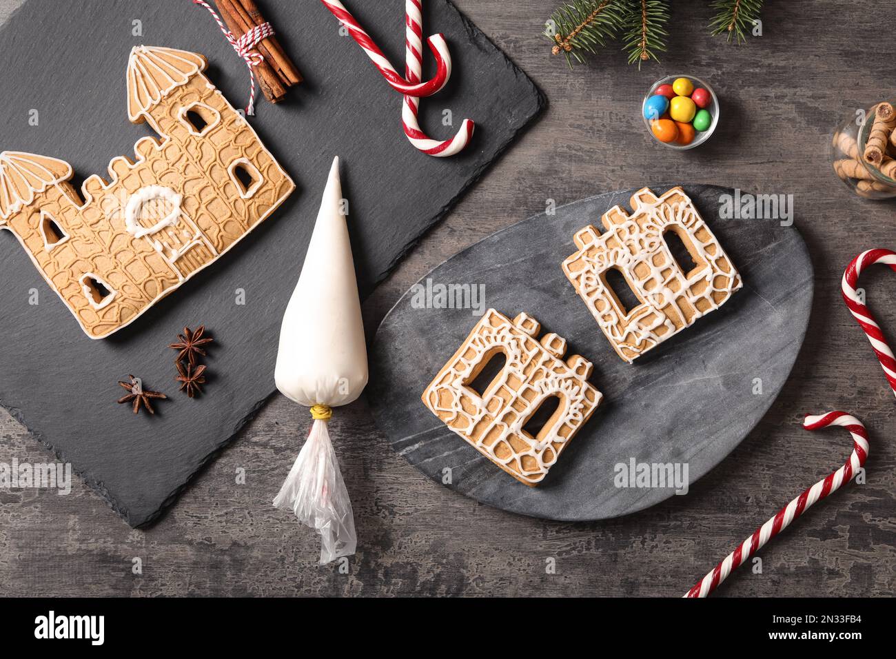 Flat lay composition with parts of gingerbread house on grey table ...