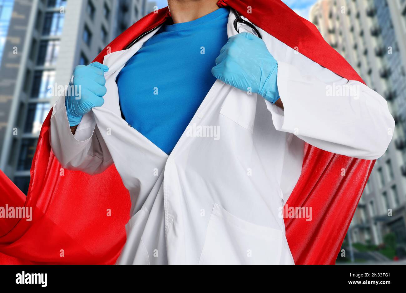 Doctor dressed as superhero on city background, closeup. Medical ...