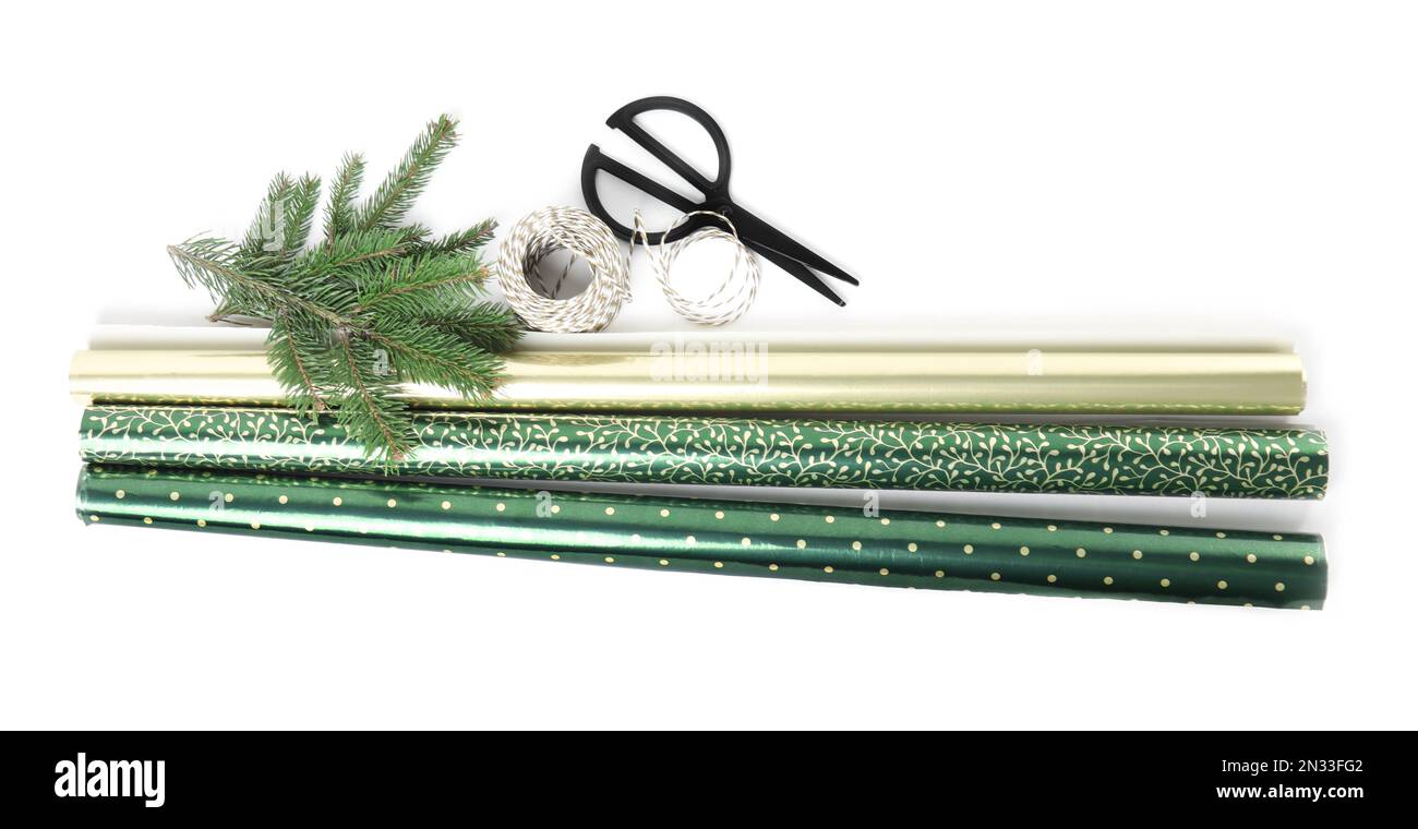 Wrapping paper rolls, rope, fir branches and scissors on white ...
