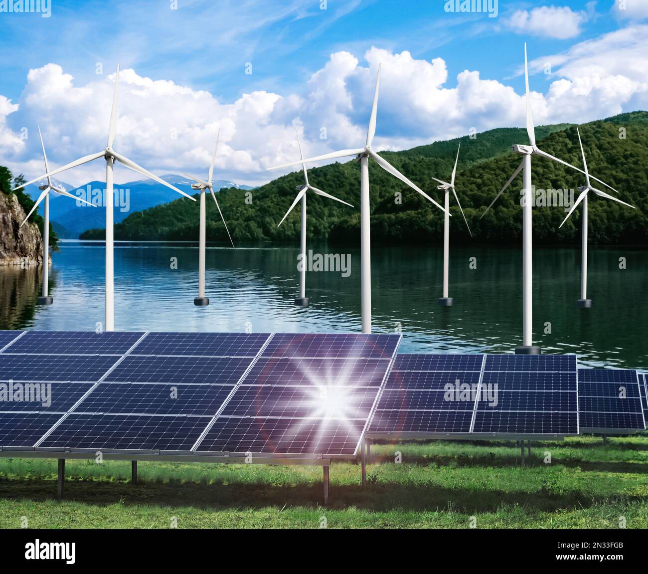 Alternative energy sources. Wind turbines installed in water near bank ...