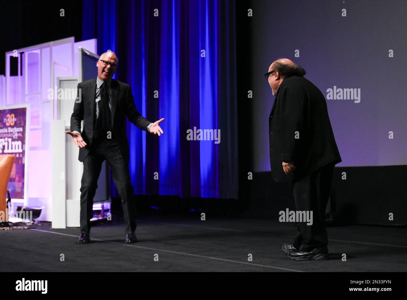 Michael Keaton, left, and Danny DeVito on stage at the 30th Santa ...