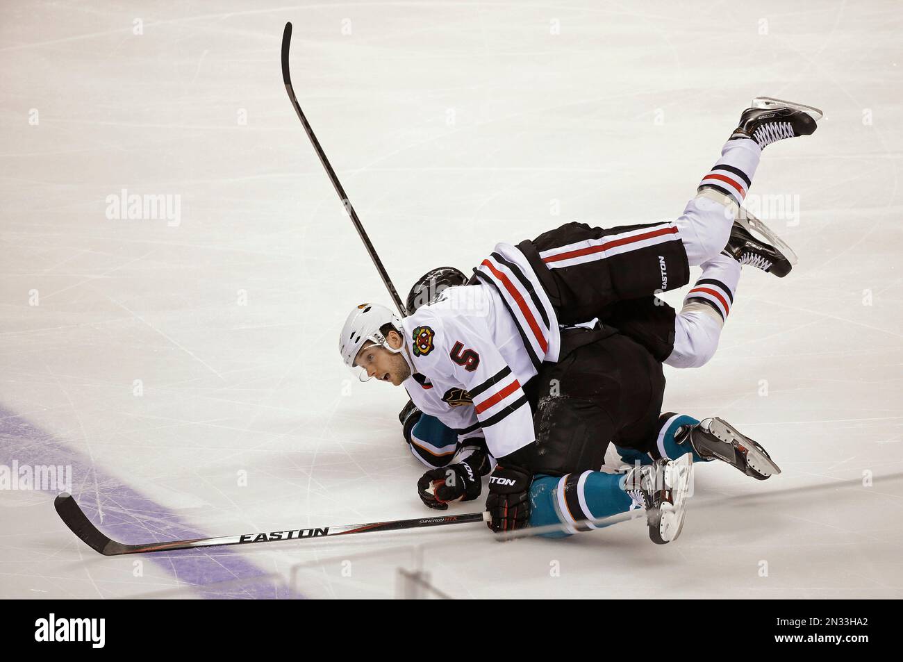 Chicago Blackhawks defenseman David Rundblad (5) goes tumbling over San ...