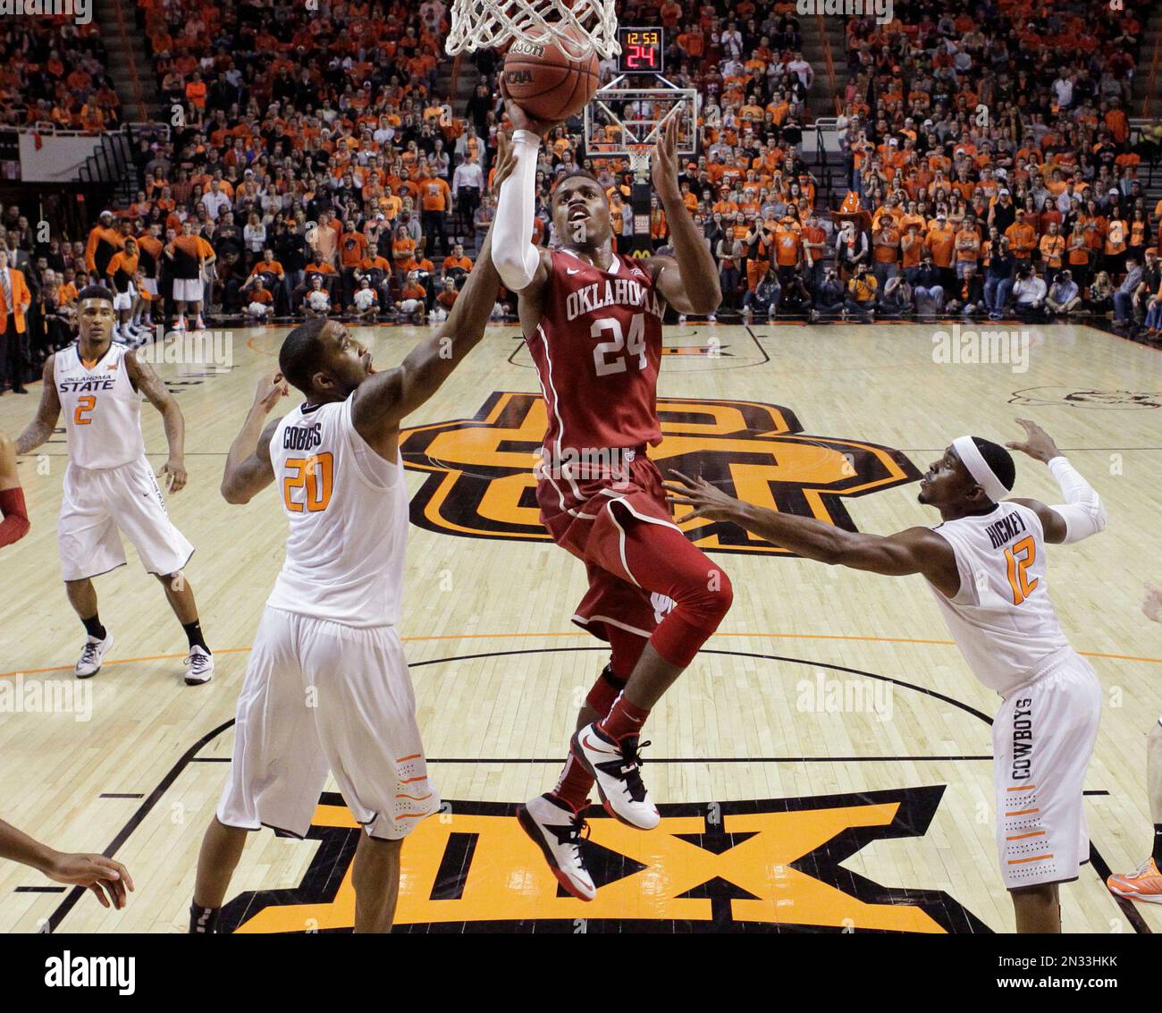 Oklahoma guard Buddy Hield (24) shoots between Oklahoma State post ...