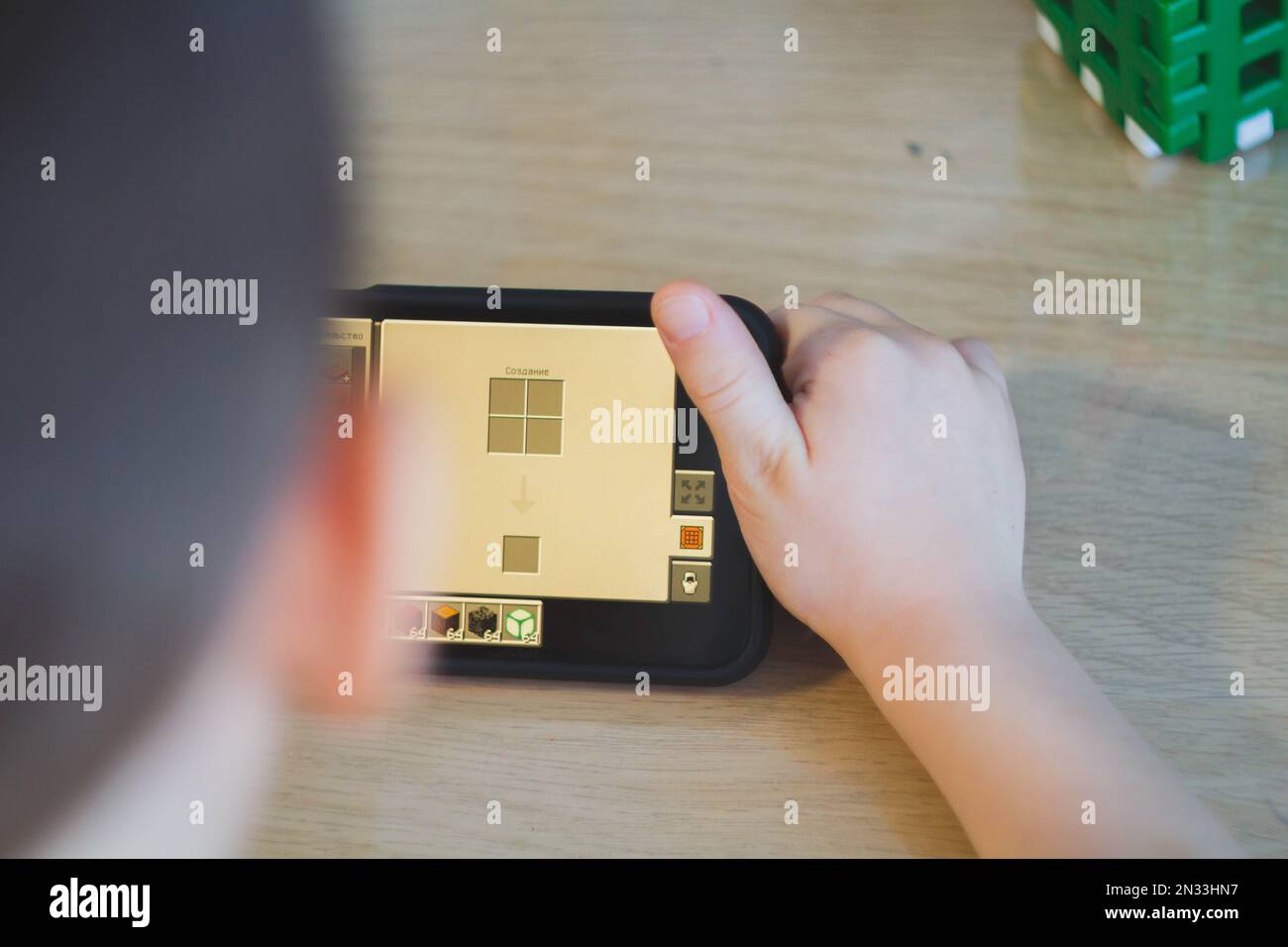 Phone in hands of child. Little boy playing mobile games on smartphone ...