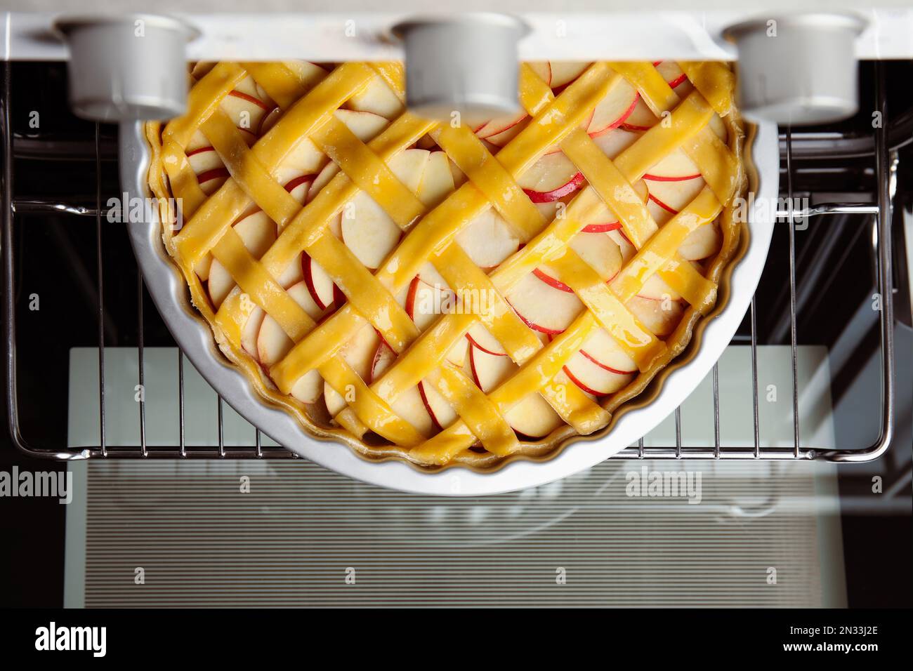 Traditional English apple pie on shelf of oven, top view Stock Photo ...